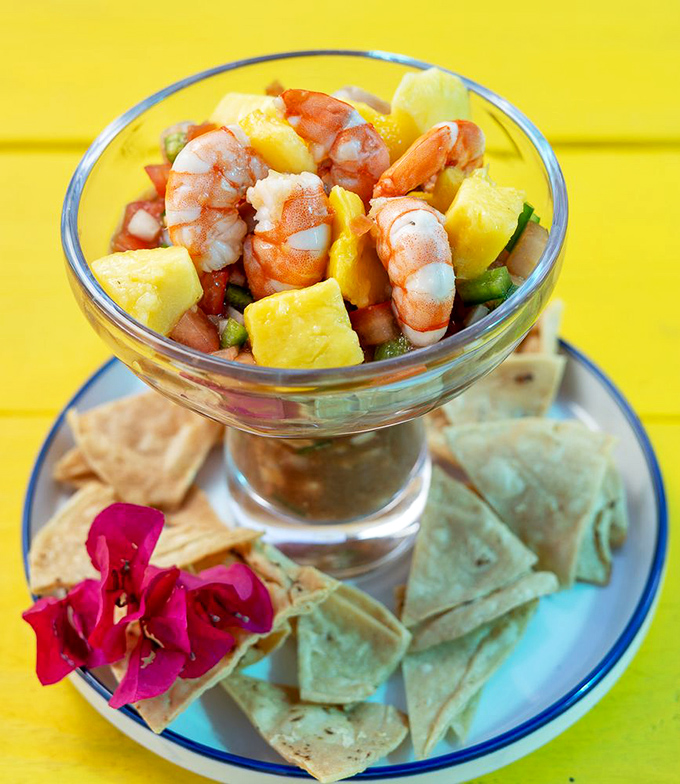 A masterclass in tropical decadence—plump shrimp mingling with sweet pineapple and crisp vegetables in a cocktail glass fit for royalty.