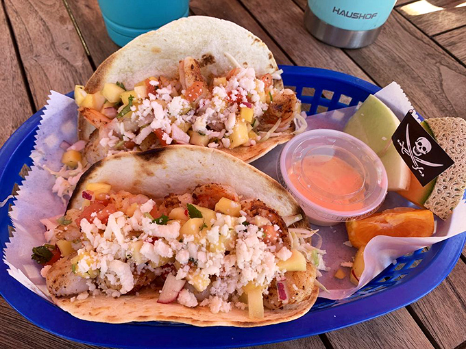 These aren't just tacos; they're love letters written in seafood, fresh vegetables, and what appears to be divine inspiration. The lime wedge is standing by for duty.