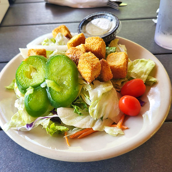 Not just a side salad, but a colorful supporting cast member with crisp greens and vibrant veggies ready for their close-up.