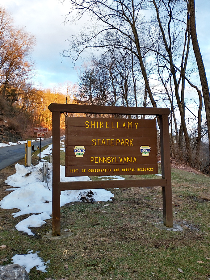 The official welcome sign stands like a friendly park ranger &ndash; sturdy, informative, and somehow managing to look good even with a dusting of snow.
