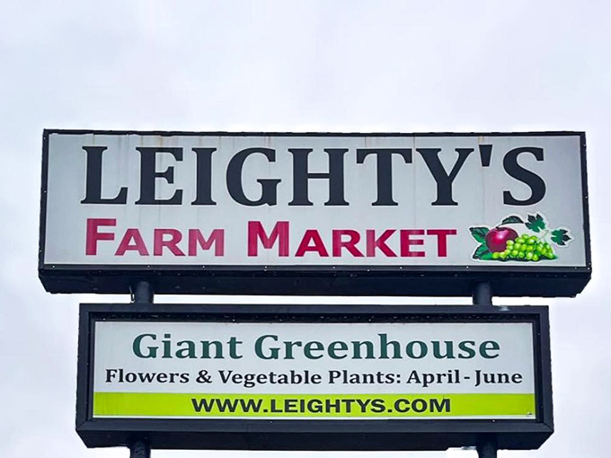 The iconic Leighty's Farm Market sign stands as a beacon to bargain hunters. Like the Bat-Signal for people who love a good deal!