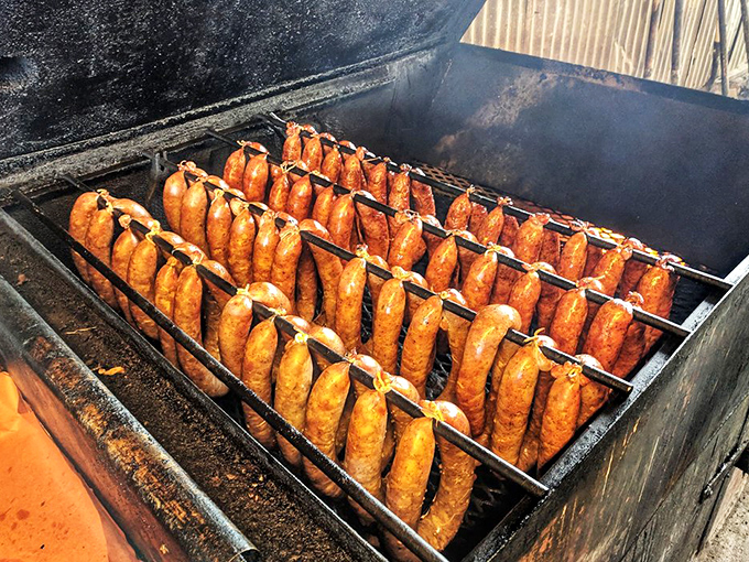 Sausages standing at attention in the smoker, their casings tightening as they transform from mere meat into cylinders of smoky perfection.