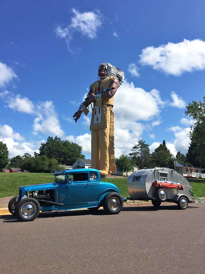 Classic Americana collision: When a vintage hot rod meets a 52-foot Native American statue, you've hit peak roadside attraction bingo.