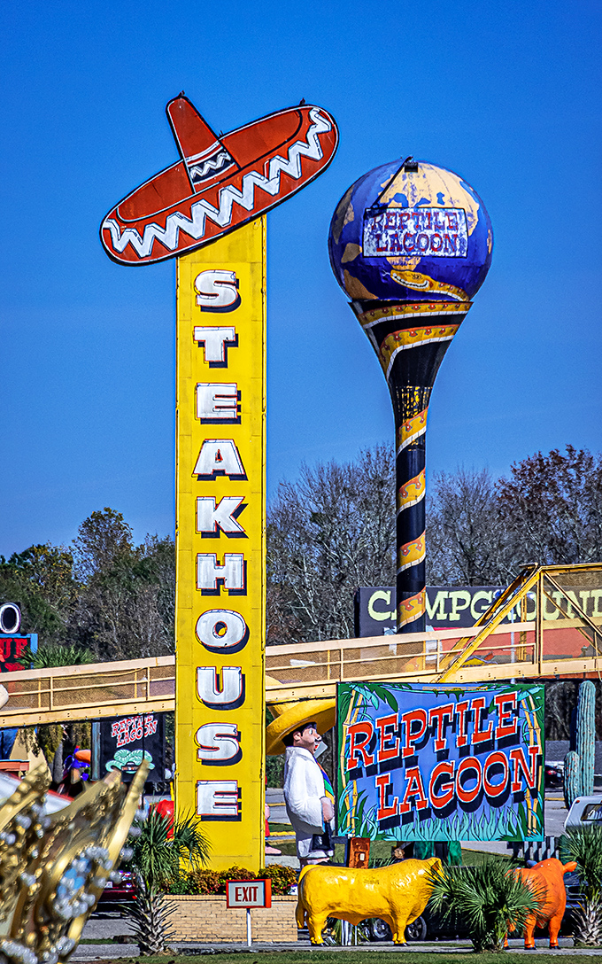 The "Steakhouse" sign towers over the landscape like a culinary lighthouse, beckoning hungry travelers with its sombrero-topped promise. 