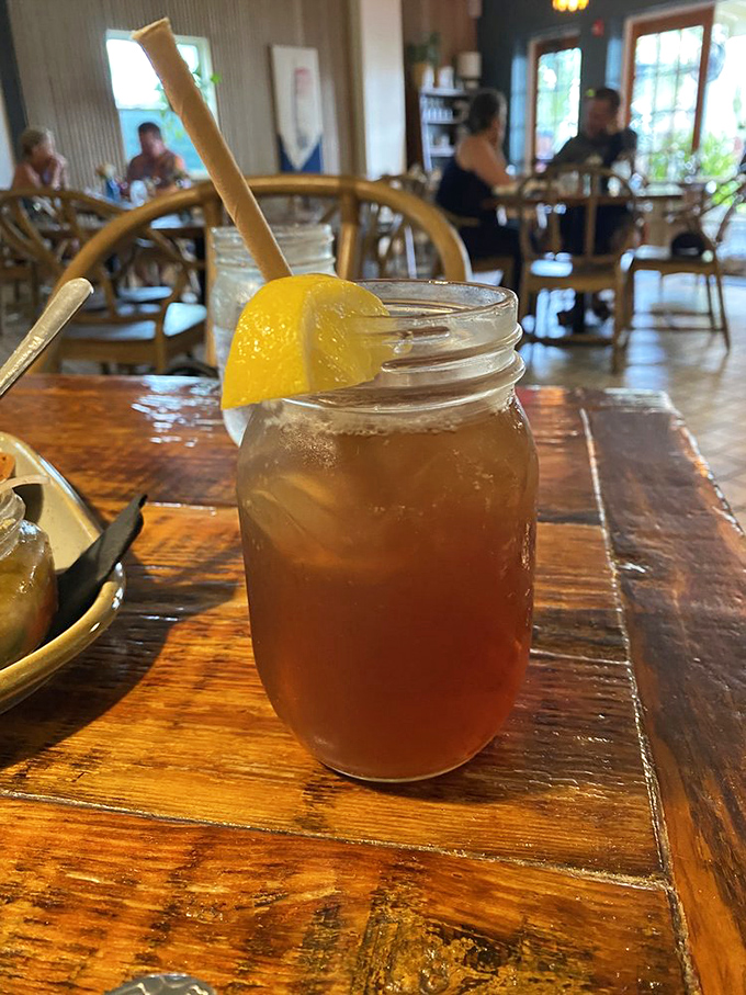 Sweet tea served in a mason jar with a paper straw&mdash;because in the South, tea isn't just a beverage, it's practically a religion.