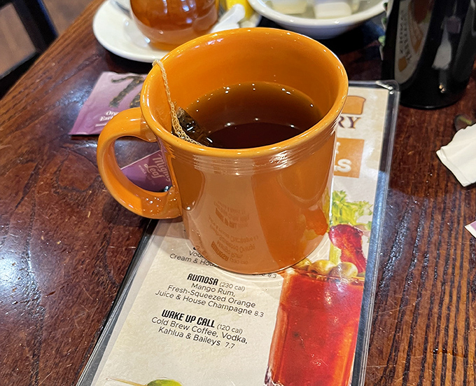That orange mug isn't just holding tea&mdash;it's cradling liquid comfort. The kind of morning companion that never interrupts your thoughts.