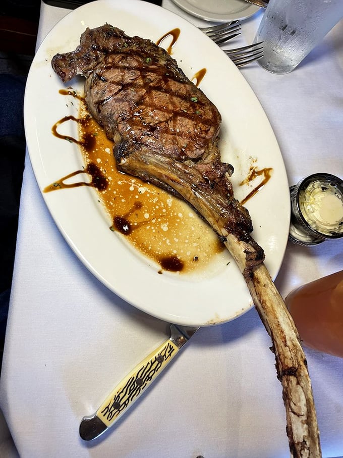 The tomahawk steak arrives like a prehistoric declaration of carnivorous intent. That bone isn't just for show &ndash; it's nature's built-in handle for your protein.