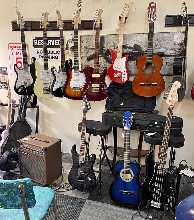 A wall of musical potential hangs ready for its next gig, from classic Stratocasters to acoustic gems waiting for new fingers to bring them to life.