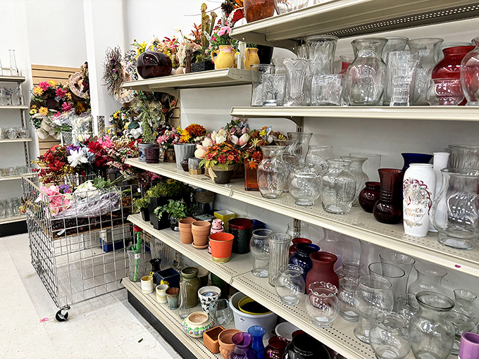 Crystal meets kitsch in the glassware aisle, where vintage vases and artificial blooms create a still life worthy of a modern Dutch master.