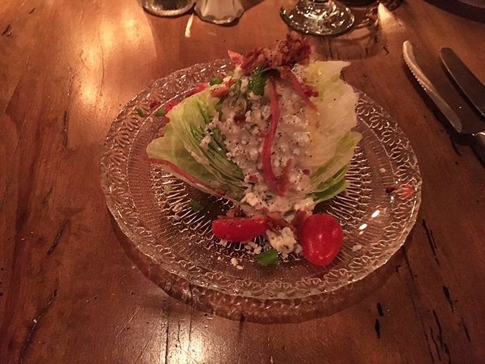 The wedge salad&mdash;that steakhouse classic&mdash;gets the royal treatment with blue cheese crumbles and cherry tomatoes on a plate fancy enough for the occasion.