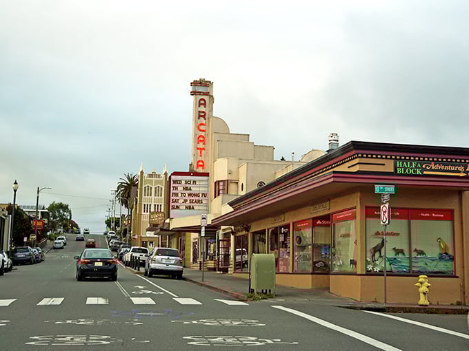 The photo captures a lively street scene in downtown Arcata, California, featuring the historic Arcata Theatre with its classic marquee and vintage charm.