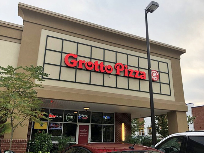 Grotto Pizza's modern storefront brings contemporary style to classic flavors. The clean lines and bright sign promise a fresh pizza experience.