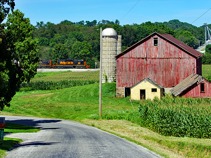 Train tracks cutting through farmland connect these quiet communities to the wider world beyond rolling hills.