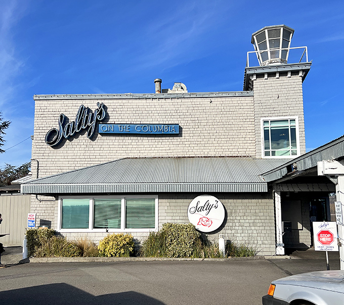 Salty's distinctive tower and blue neon sign stand sentinel over the Columbia River, promising seafood with a spectacular view.