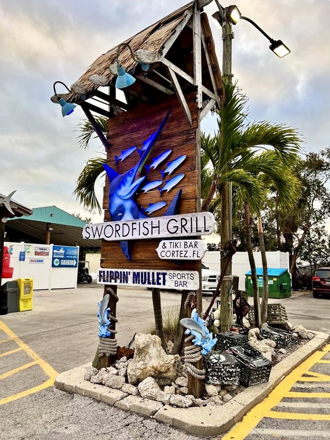 The Swordfish Grill's wooden sign stands tall like a maritime beacon, guiding hungry seafood lovers to grouper sandwich nirvana.