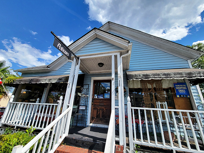 Charming blue cottage exterior promises cozy antique discoveries waiting inside for patient treasure hunters