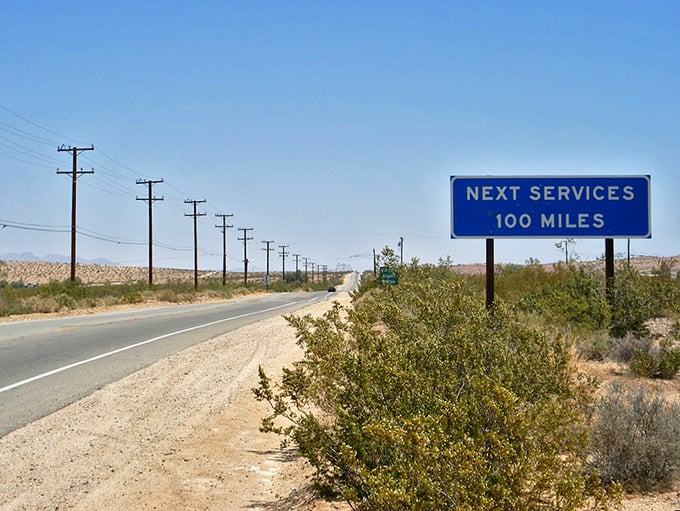 The Mojave Desert stretches endlessly under a perfect blue sky, like nature's version of a minimalist painting.
