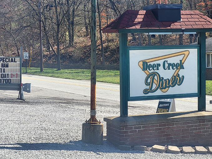 The Deer Creek Diner's charming roadside sign stands as a welcome invitation to hungry travelers seeking authentic country cooking.