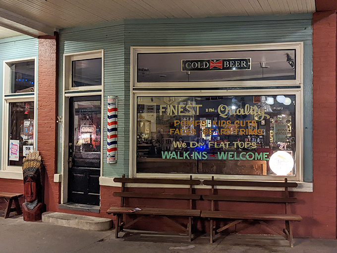 The warm glow of Emporium Antiques' window displays beckons passersby. "Cold Beer" and "Quality" signs&mdash;they knew what mattered back then!