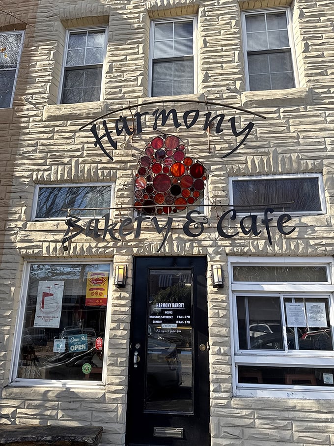 Sunlight plays across Harmony's historic facade. Those windows have witnessed countless smiles triggered by exceptional pastries!