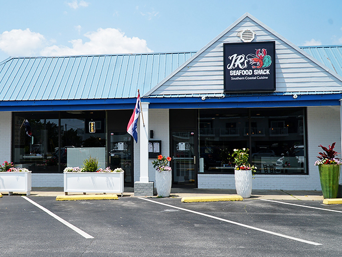 Bright flowers welcome you to JR's unassuming building, where Southern coastal magic happens without any fancy pretense.