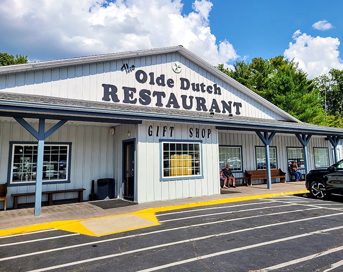Sunshine bathes The Olde Dutch Restaurant, where locals gather on the porch to debate which pie flavor reigns supreme.