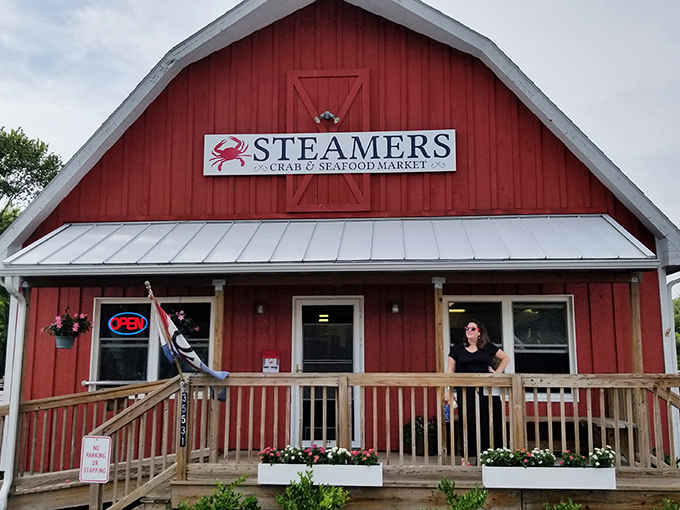 The red barn exterior houses seafood treasures within. That wooden porch practically begs you to sit a spell with a bag of steamed crabs.