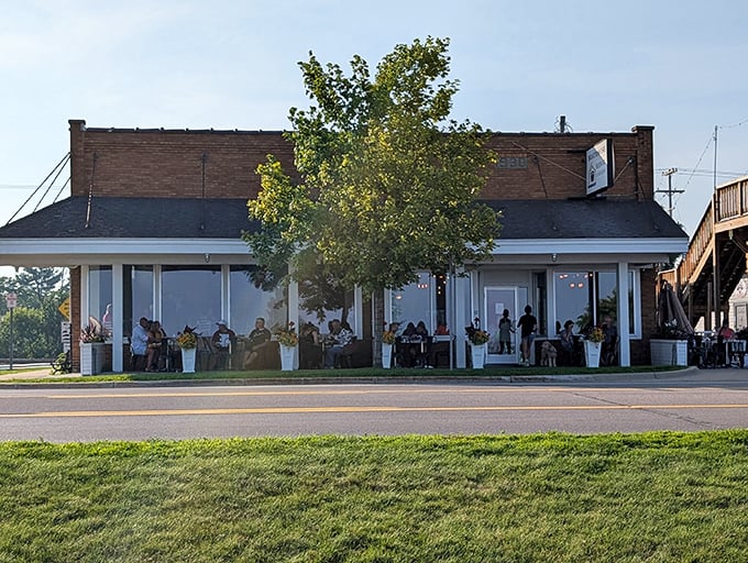 The sunset casts a golden glow on Tawas City's waterfront restaurant, where dinner comes with a side of spectacular views.
