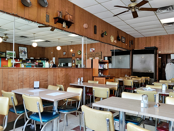 The dining room whispers stories of countless conversations, business deals, and first dates that have unfolded under these ceiling fans.