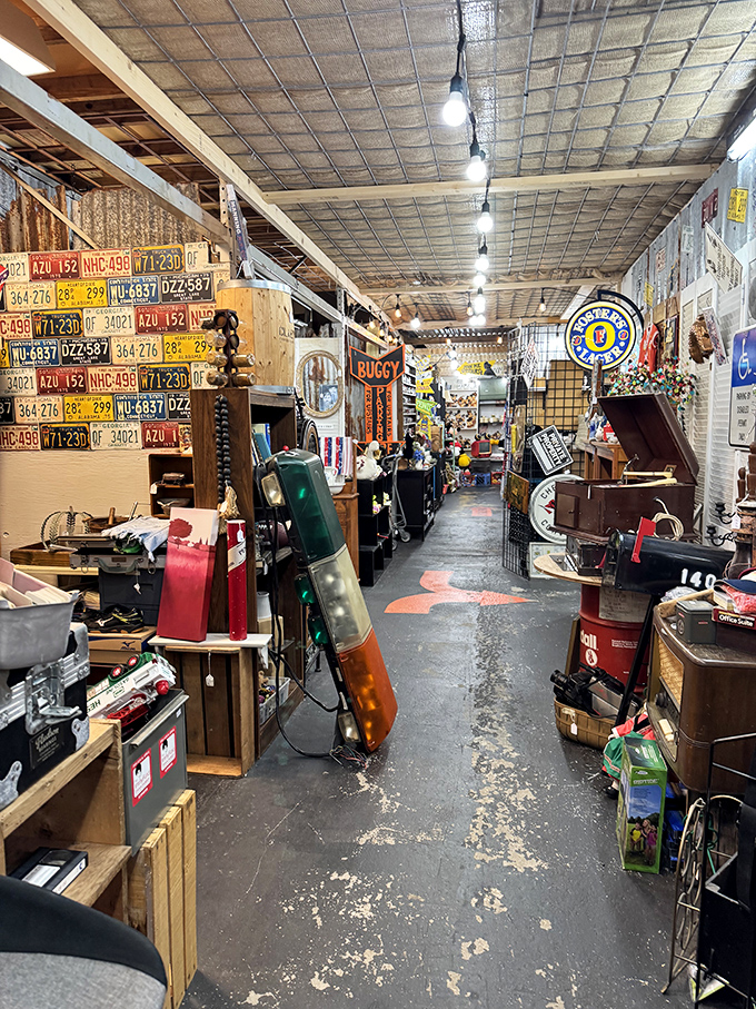 License plates line the walls like a road trip through America's past. This narrow passage feels like the coolest garage sale you've ever wandered into.