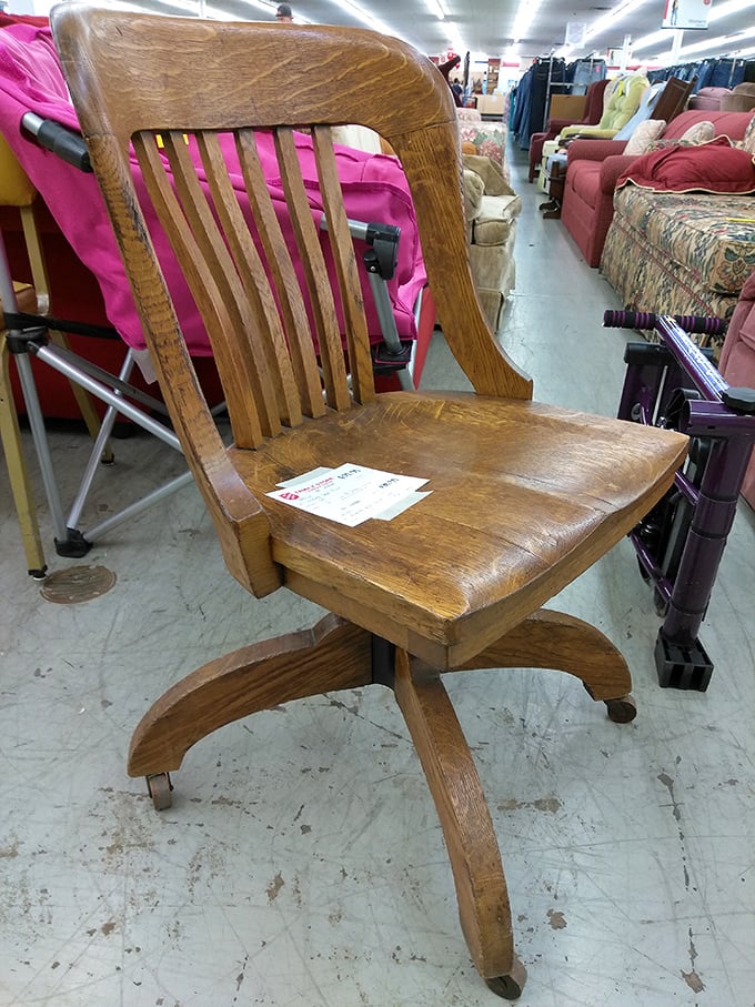 This wooden swivel chair has probably supported someone drafting a novel, balancing a checkbook, or perhaps planning world domination.