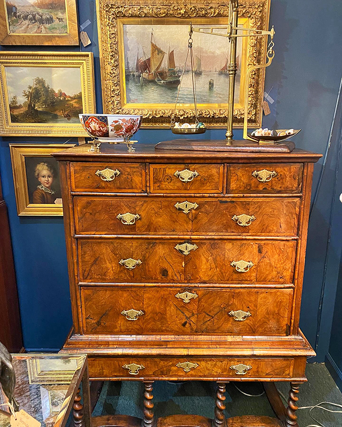 This burled wood chest of drawers isn't furniture&mdash;it's functional sculpture. The brass scale above seems ready to weigh your wallet against your wants.