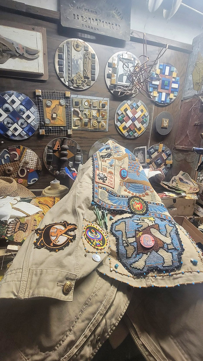 A cozy corner of creativity, where a wall of intricate mixed-media art watches over a jacket adorned with colorful beaded patches and pins&mdash;proof that art doesn&rsquo;t stay on the walls, it lives with the artist.