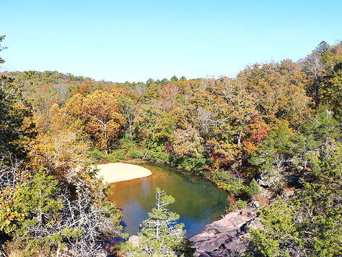 Fall foliage creates a golden crown around the emerald pool. The Ozarks dress up for their seasonal portrait.