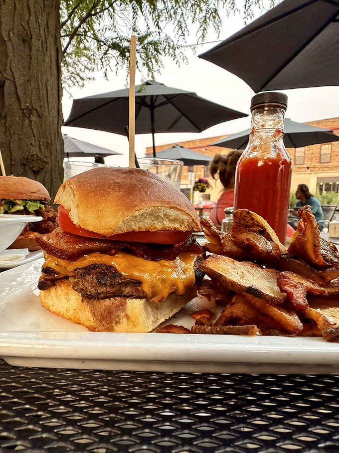 A burger that requires jaw exercises beforehand. Melted cheese cascading down beef with bacon standing guard&mdash;comfort food wearing a tuxedo.