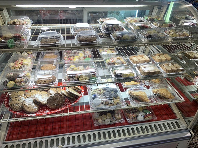 The dessert case&mdash;where willpower goes to die. Each plastic container holds a sweet promise that "just coffee" was never really the plan.