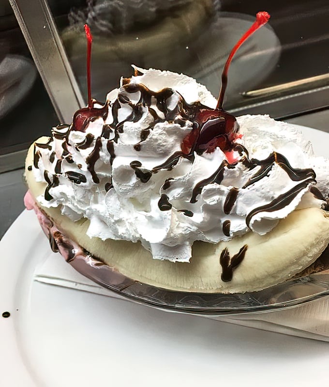 This banana split isn't dessert&mdash;it's performance art. A mountain of whipped cream, chocolate drizzle, and those signature cherries create edible nostalgia.