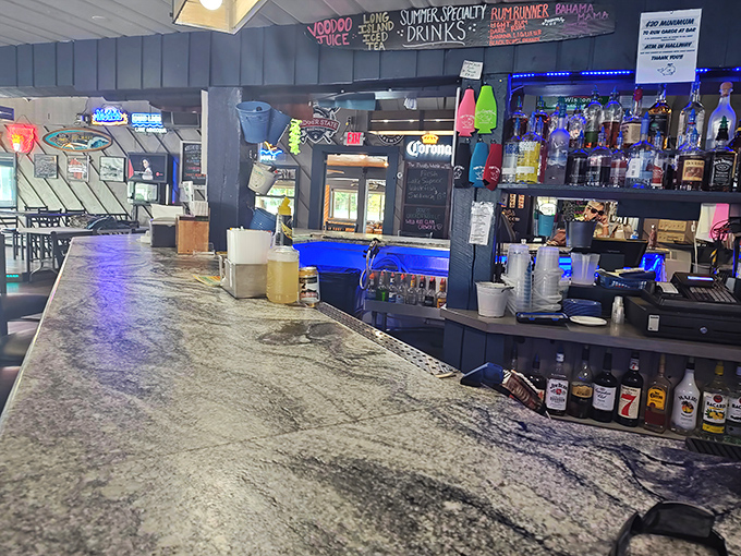 The bar area balances rustic charm with lakeside functionality &ndash; the kind of place where strangers become friends over stories of "the one that got away."