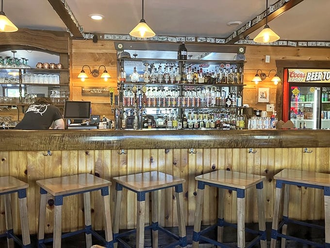 The bar area strikes that perfect balance between "rustic charm" and "I can actually see what I'm drinking," with wooden stools that invite you to settle in.