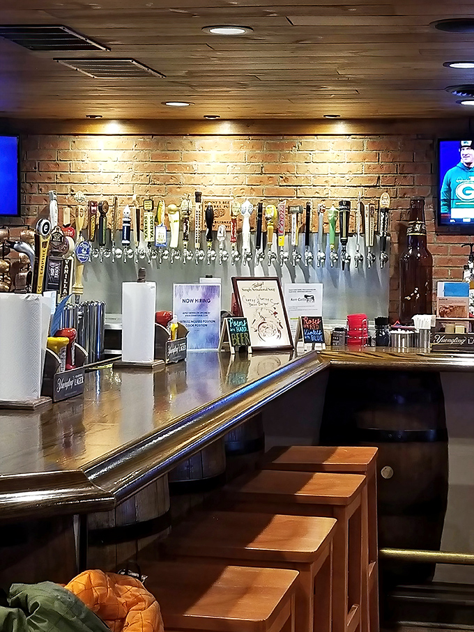 The bar area beckons with dozens of taps, where local brews stand ready to complement (or help you forget) your burger challenge defeat.