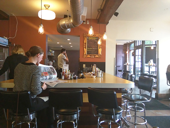 The counter seats offer front-row tickets to the breakfast show&mdash;where newspaper reading and coffee sipping become Olympic sports.