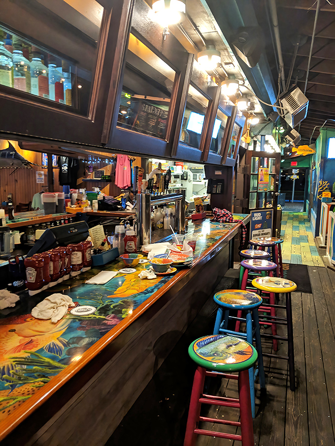 Bar art that puts museum collections to shame. Colorful stools and a hand-painted countertop where elbows rest while waiting for liquid refreshment.