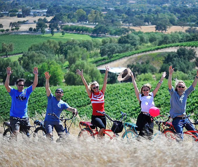 Wine country cycling at its finest—where the joy isn't just reaching your destination, but throwing your hands up to celebrate the journey itself.