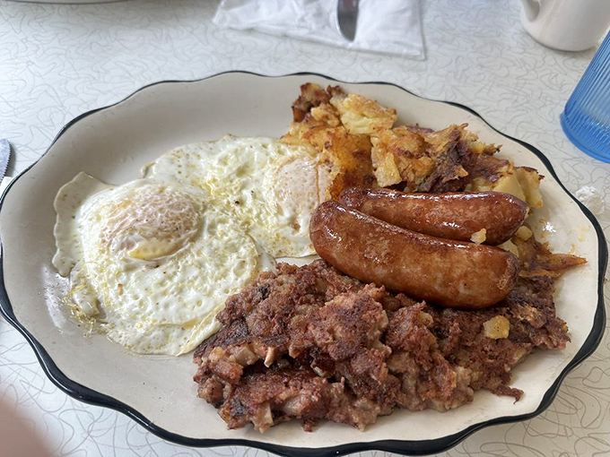 The breakfast platter that answers the eternal question: "Why choose?" Eggs, sausage, corned beef hash, and home fries in perfect harmony.