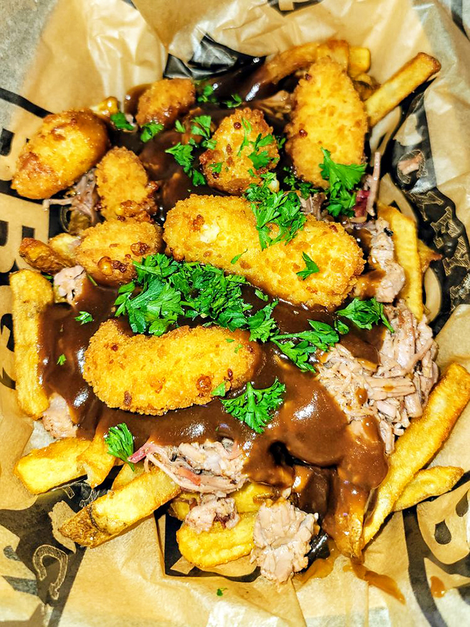 Pulled meat, gravy, and golden-fried bites create a plate that's part comfort food, part work of art, and entirely worth the napkin investment.