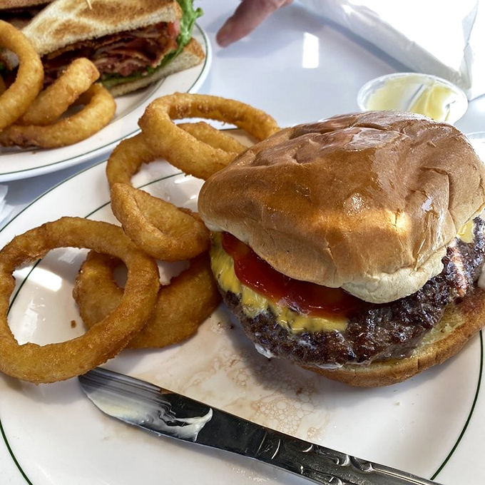 A burger that requires both hands and a strategy, flanked by onion rings that could double as golden bracelets &ndash; if they weren't so irresistible.