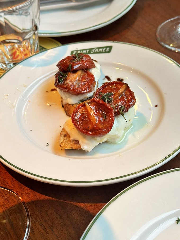 Roasted tomatoes lounging on toasted bread like sunbathers on a beach, with creamy burrata playing the role of fluffy clouds.