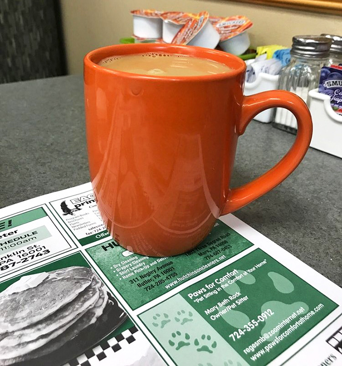 That distinctive orange mug signals serious coffee business &ndash; the kind that's refilled before you realize you need it, keeping conversations and days flowing smoothly.