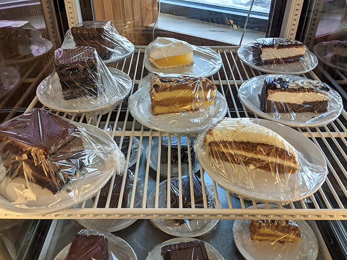 A display case of temptation where willpower goes to die. Each slice promising that diet starts tomorrow, not today.