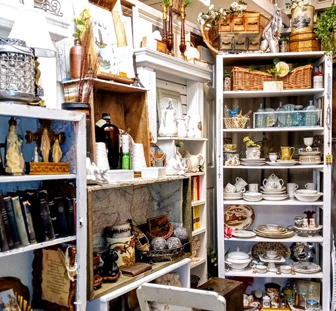 White shelves lined with china and collectibles – organized chaos that makes Marie Kondo nervous but sparks joy in treasure hunters.